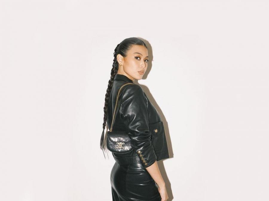 Michelle Dee tops all-black ensemble with a designer bag